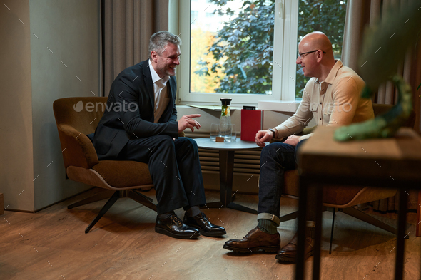 Men communicate in the recreation area by the window Stock Photo by ...