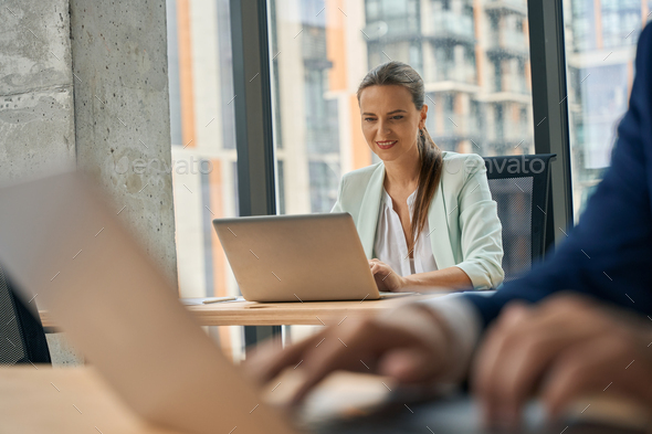 Successful lady in business suit working at her office desk Stock Photo ...