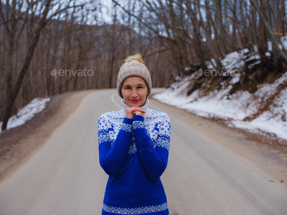 Beautiful woman standing among trees in winter forest Stock Photo by ...