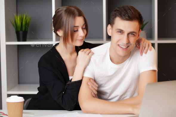 Loving couple working successfully together on their own business in ...