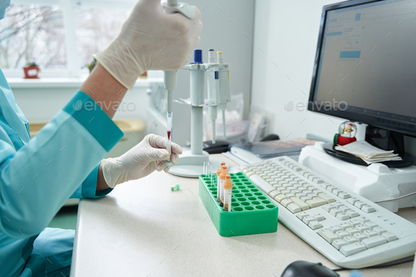 Female laborant working with blood tests in hospital Stock Photo by ...