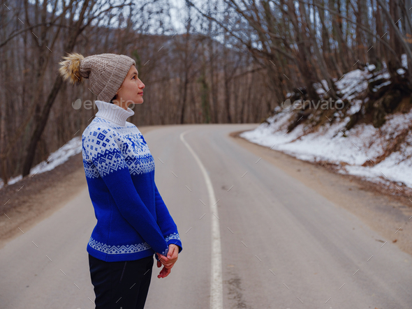 Beautiful woman standing among trees in winter forest Stock Photo by ...