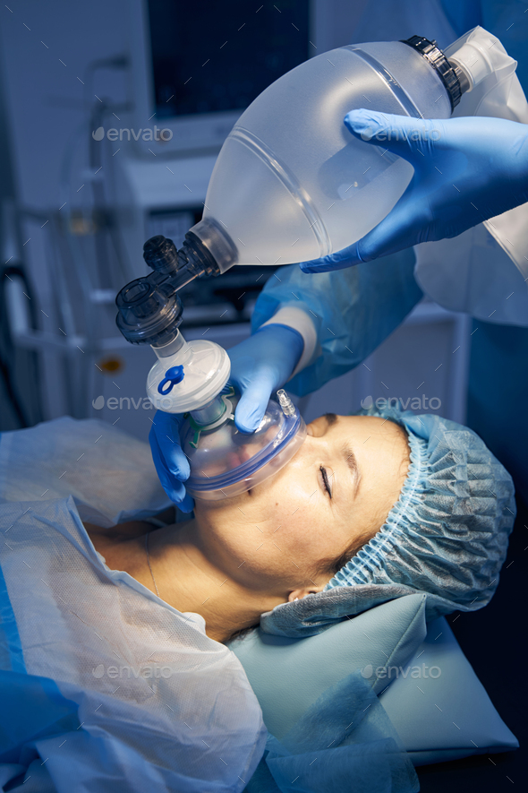 Female patient getting anesthesia before the operation Stock Photo by ...