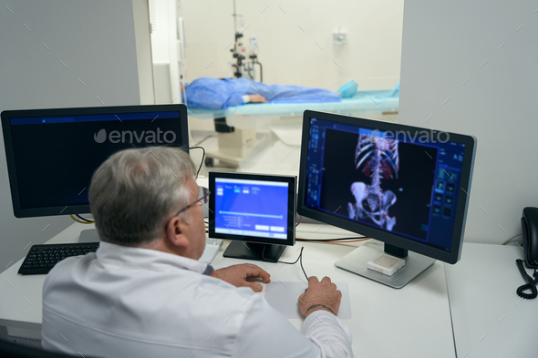 Male diagnostician performs a CT scan using modern equipment Stock ...