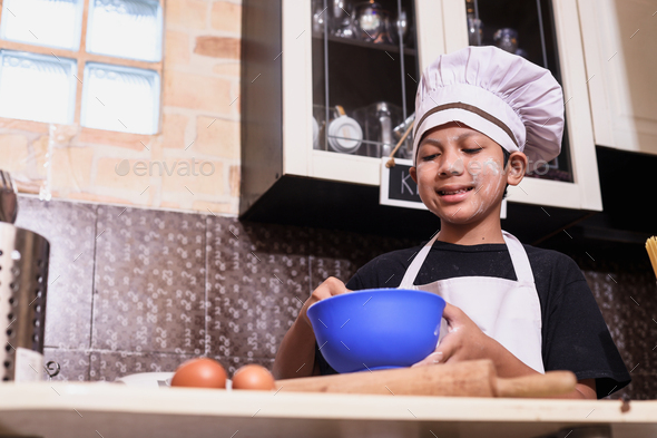 Low angle of little chef cooking Stock Photo by Queenmoonlite35 | PhotoDune