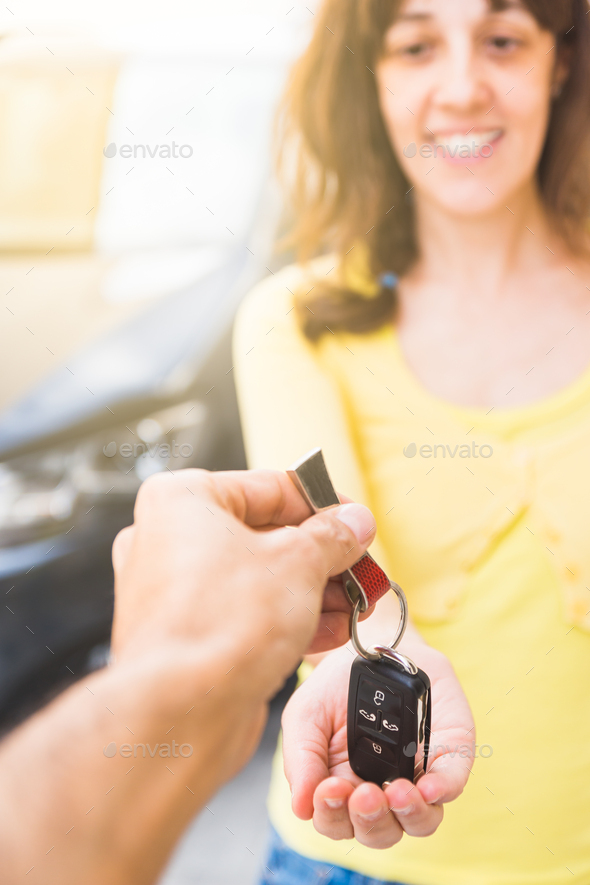 smiling young girl receives keys to her new car Stock Photo by alfotomp