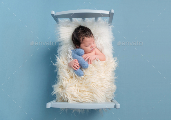 Baby cuddling with his toy, topview Stock Photo by tan4ikk | PhotoDune