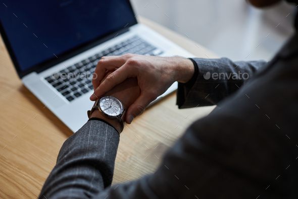 Close-up man checking the time on his stylish wrist watch. People ...