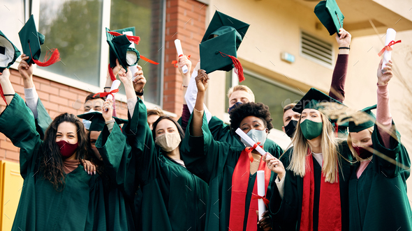 Large group of happy students with protective face masks celebrating ...