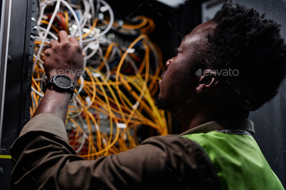 Network technician connecting cables in data center Stock Photo by ...