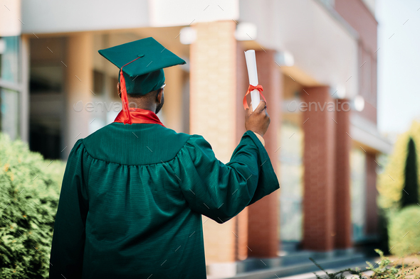 Rear view of black graduate student with college diploma. Stock Photo ...