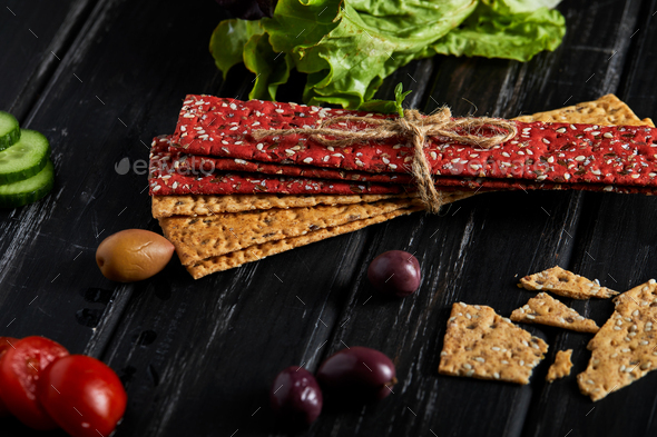 Beetroot and rye flour crackers with vegetables for making snacks on a ...