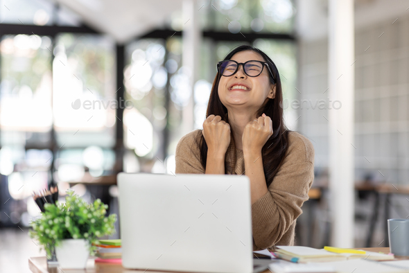 Portrait of Happy Excited young asian woman at workplace office desk ...