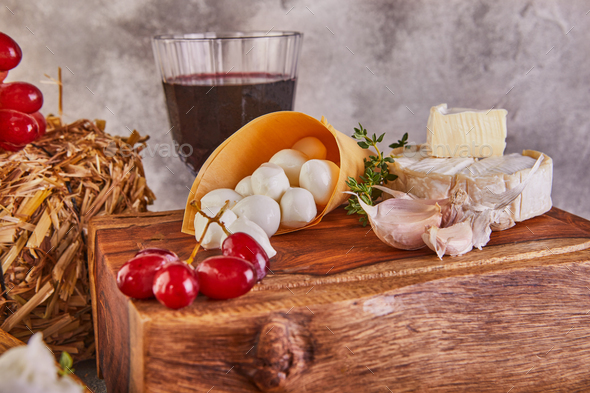 Mozzarella baby brie cheese and mozzarella mural with garlic and grapes ...