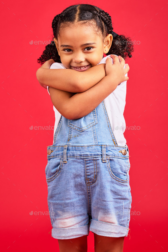 Portrait, hug and girl in studio, happy and smile against red ...