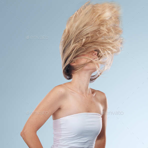 Hair, beauty and woman in studio happy dance and head shake fun on grey ...