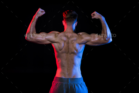 back view of shirtless bodybuilder gesturing isolated on black with ...
