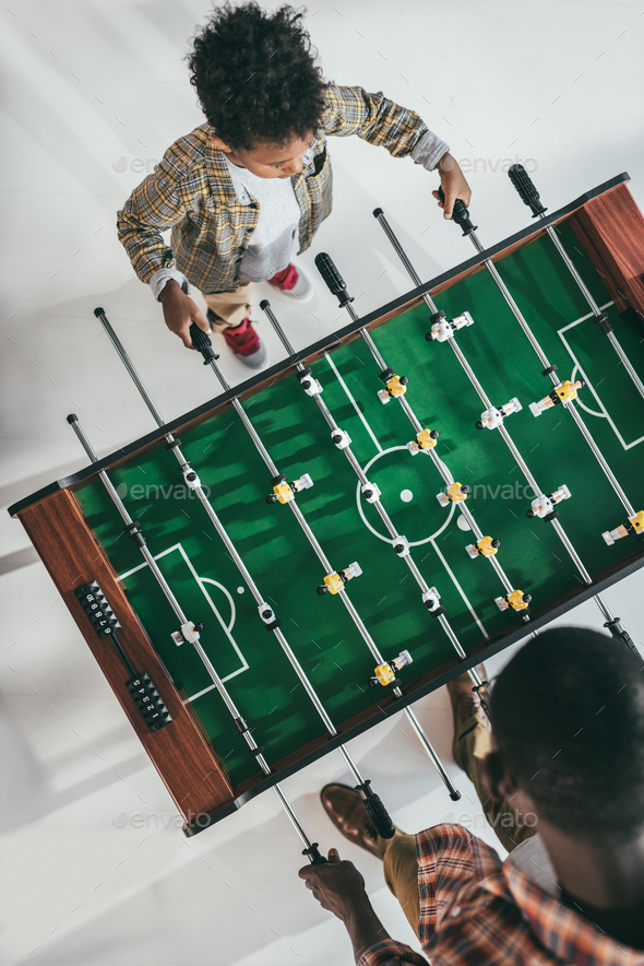 top view of father and little son playing table football Stock Photo by ...