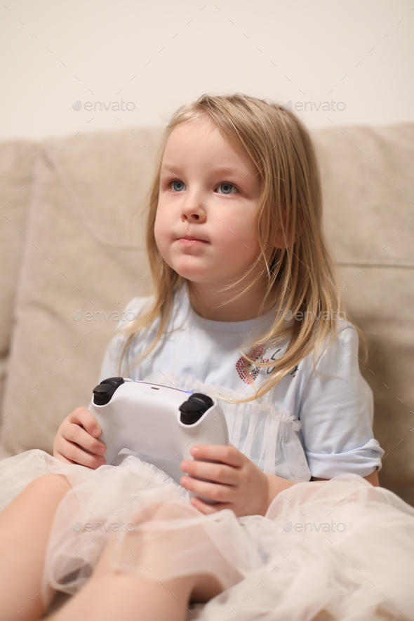 Kids Gaming video games concept. Toddler or young girl playing game ...