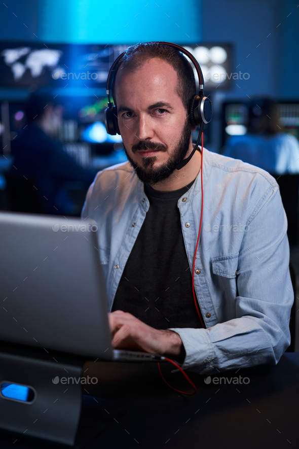 Vertical Portrait looking at camera of a Stock Market Trader Working ...