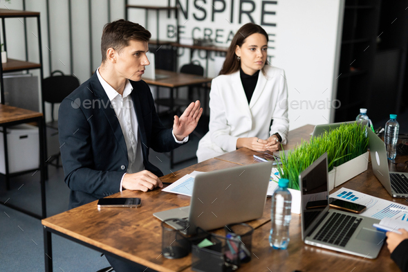 business negotiations in the office at a large desktop between ...