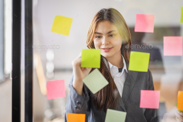 Business Asian female employee with many conflicting priorities ...