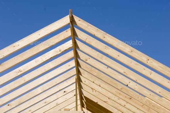 Low angle view of a lumber construction under a blue sky and sunlight ...