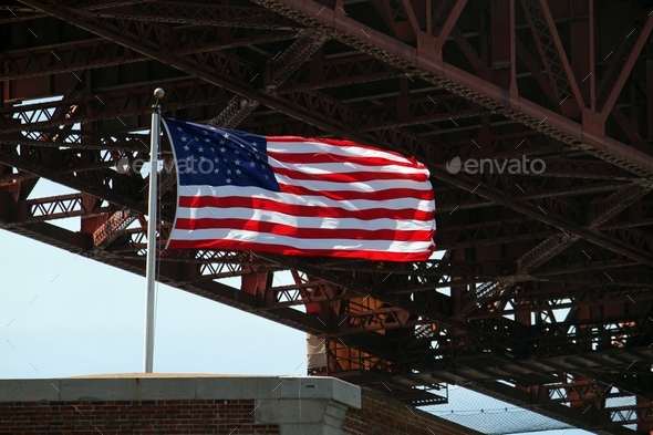 Low angle shot of the US flag under a metal construction Stock Photo by ...