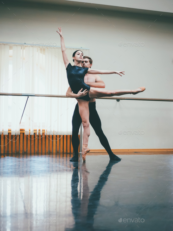 Man practicing in ballet with partner ballerina woman in black clothing ...