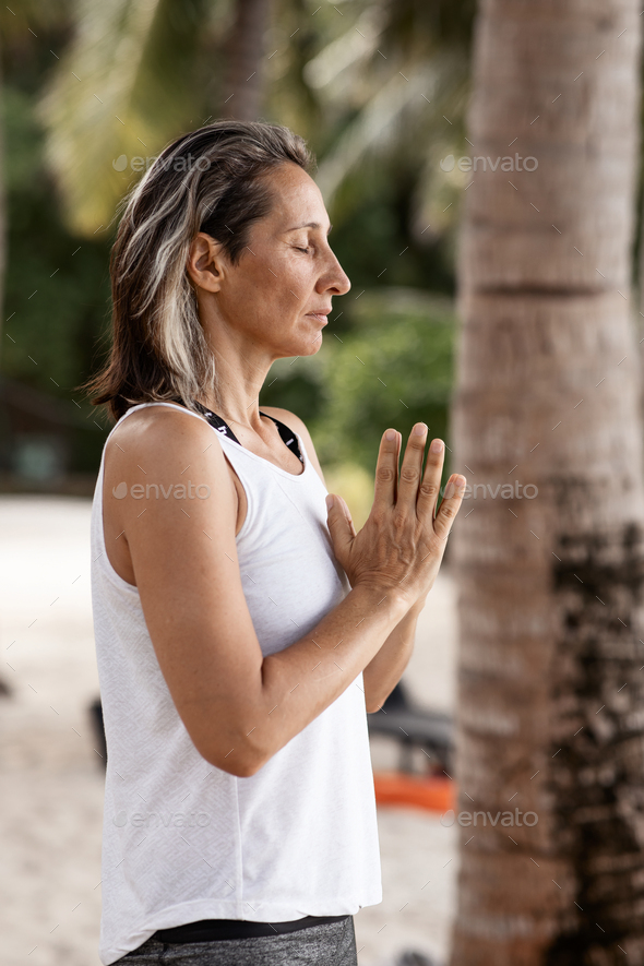 a fit, slender middle-aged female yoga instructor performs asanas Stock ...