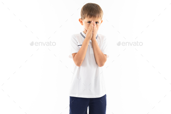 outgoing boy with bangs in a white t-shirt on a white background with ...