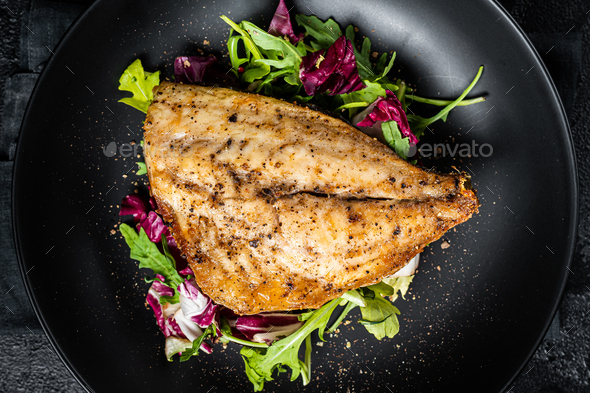 Grilled Sea Bream Dorado fillets served on fresh salad. Black ...