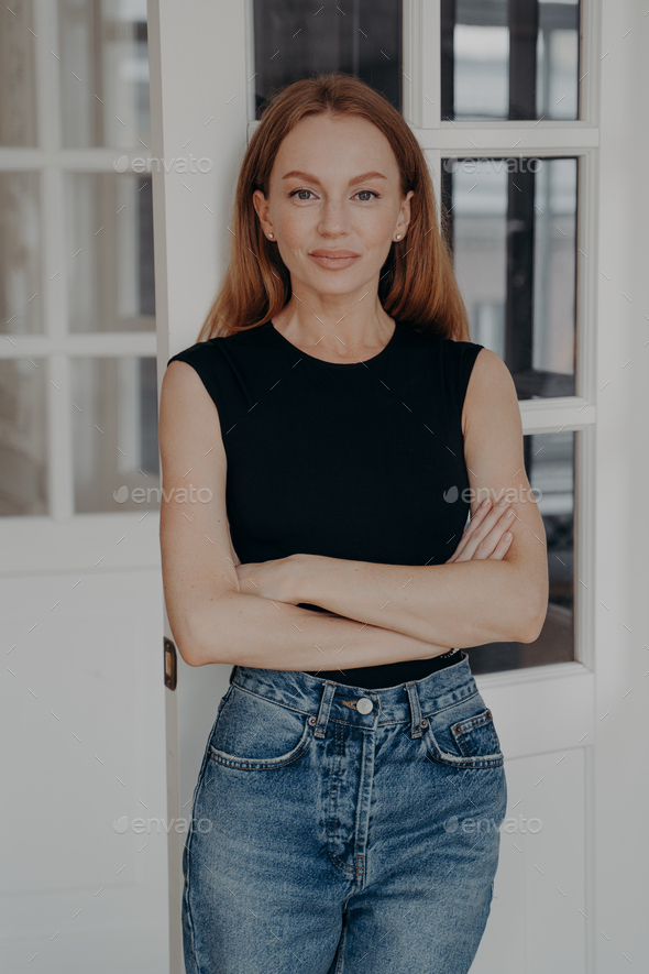 Middle age model is standing and smiling. Portrait of confident elegant ...