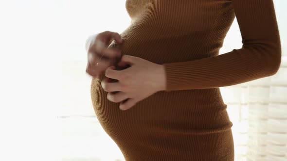 Closeup of the Pregnant Woman Standing Scratching Her Stomach Near the ...