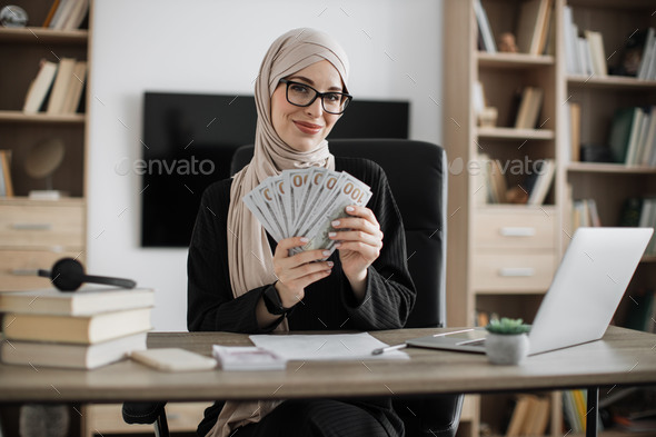 Accounting, taxes and finances concept - young confident muslim woman ...