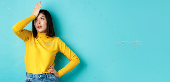 Emotions and lifestyle concept. Annoyed asian girl roll eyes and face ...