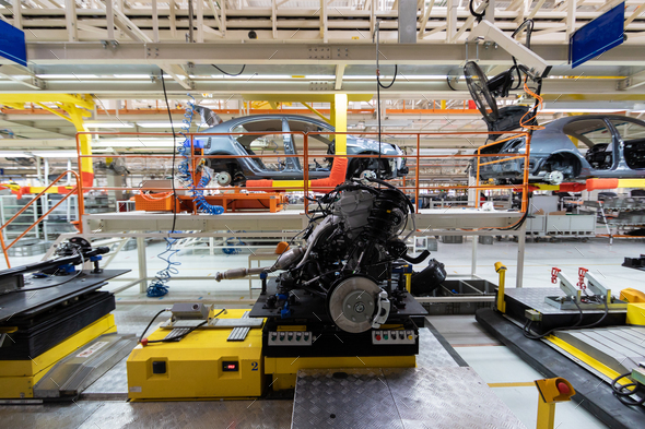 Transfer of car body. Robotic equipment makes Assembly of tcar. Modern ...