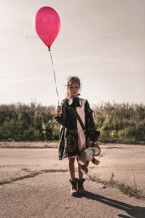 cute kid with gas mask holding red balloon, post apocalyptic concept ...
