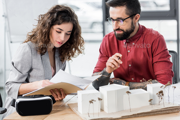 virtual reality architects sitting at table and doing paperwork Stock ...