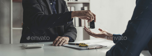 Car rental and Insurance concept, Young salesman giving car is key to ...