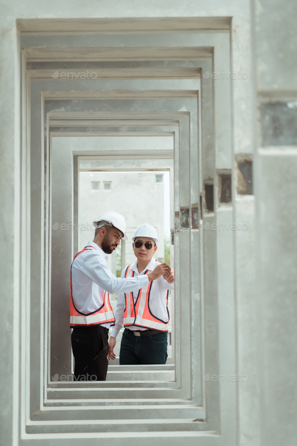 Both of construction engineers verify the constructed precast concrete ...