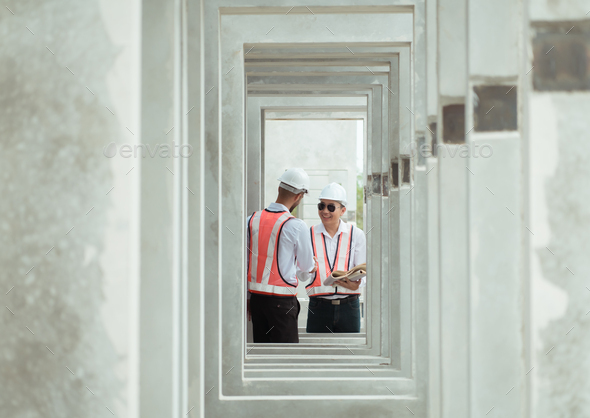 Both of construction engineers verify the constructed precast concrete ...
