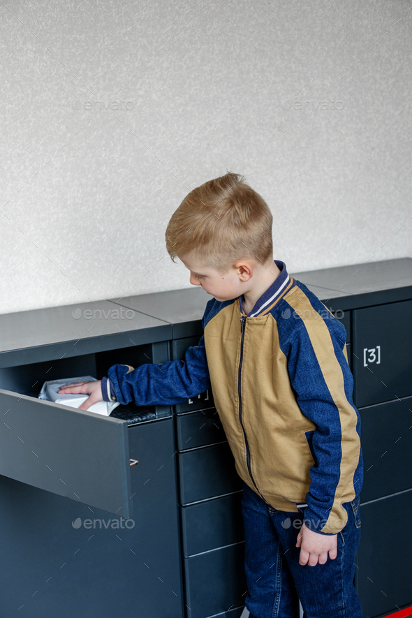 Boy client using automated self service post terminal machine or locker ...