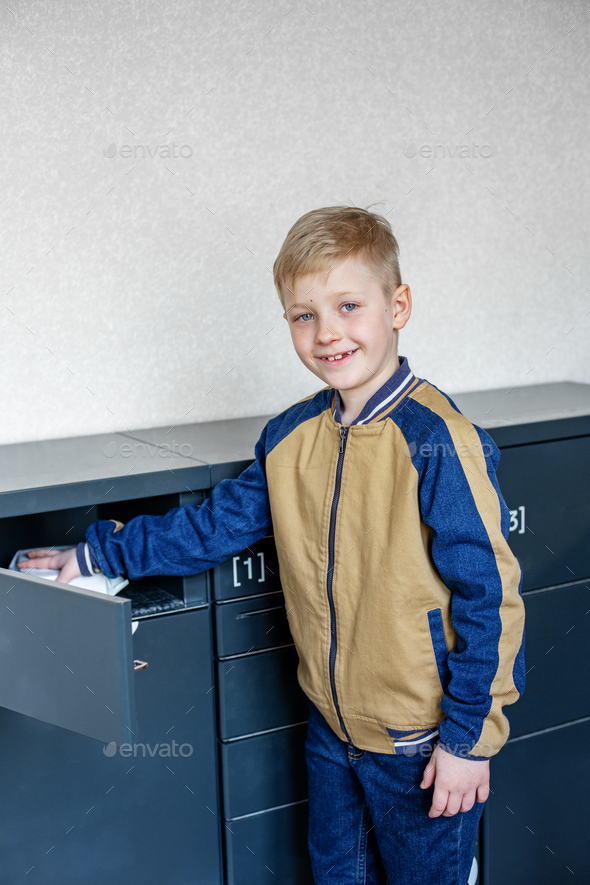 Boy client using automated self service post terminal machine or locker ...