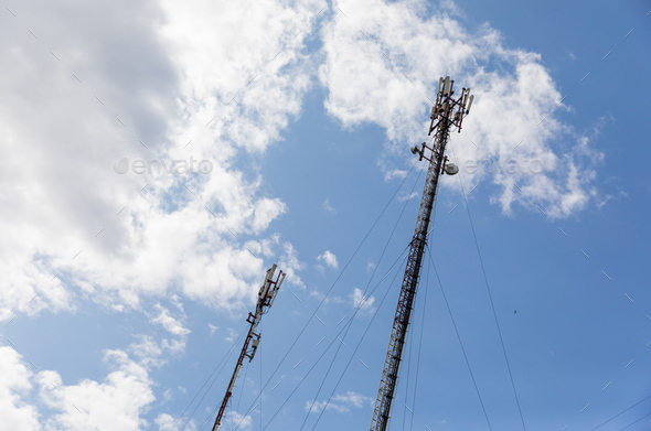 Red and white mobile phone cell tower repeater, with a small microwave ...
