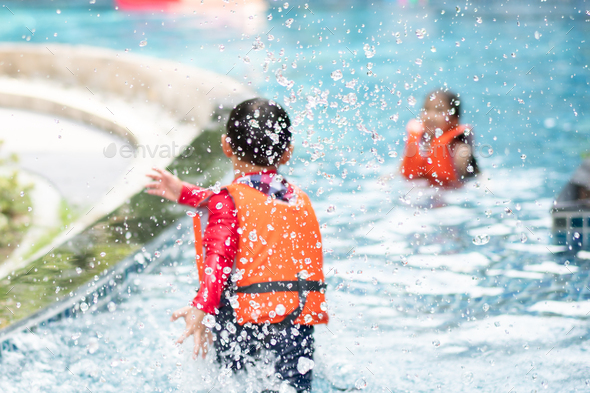 Background of kids playing splash water in swimming pool Stock Photo by ...