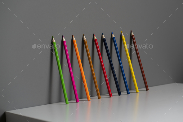 creative colorful crayons layout with the hard shadows on the wall ...