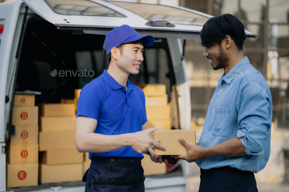 Male hand accepting delivery of box from delivery man in the morning ...