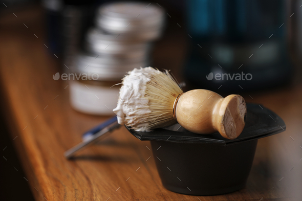 Set of shaving equipment and men's cosmetic products on wooden table ...