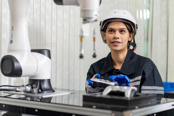 Engineer Man working at industrial robot in factory industrial. robotic ...